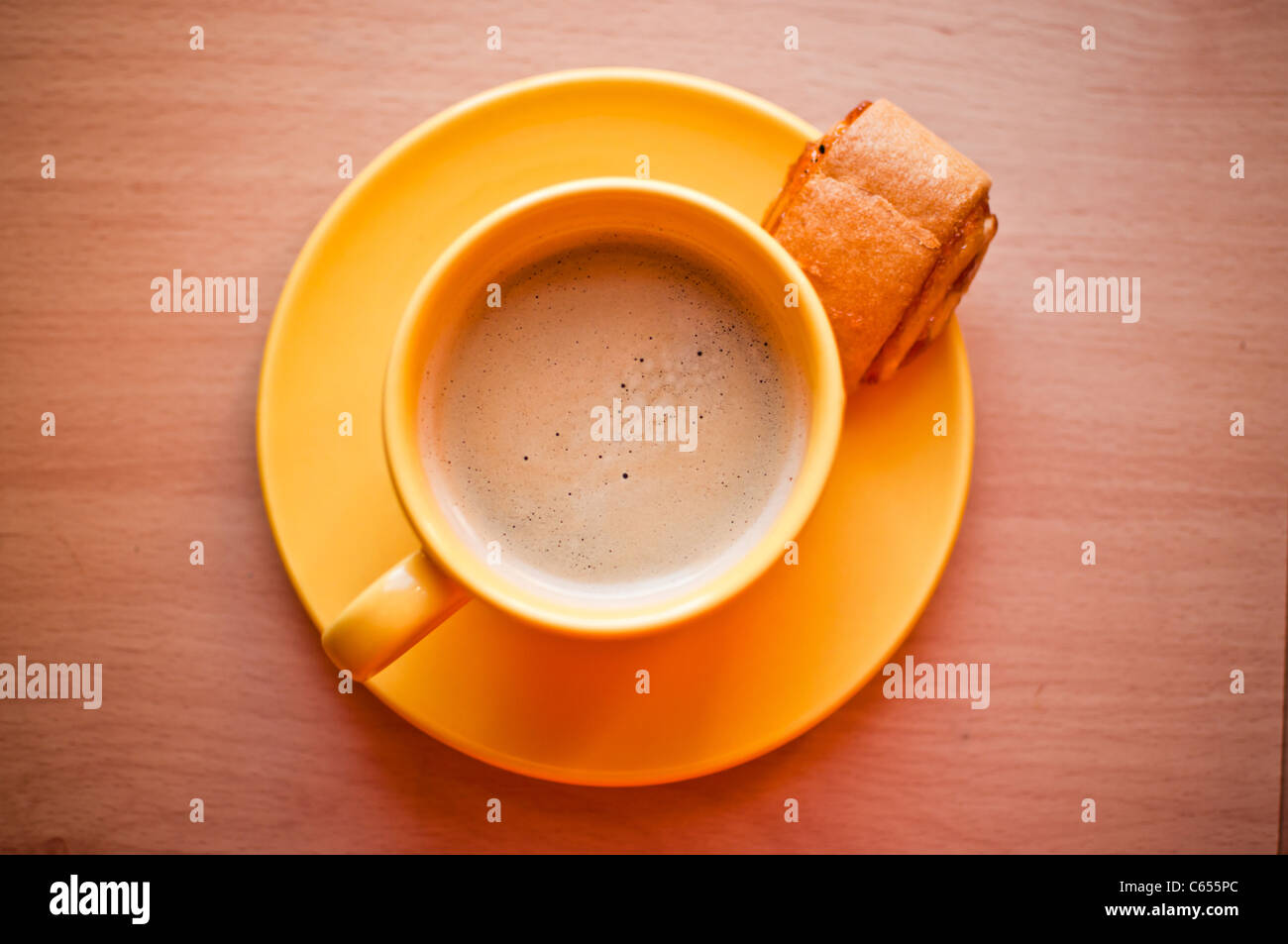 Coffee in an yellow cup Stock Photo - Alamy