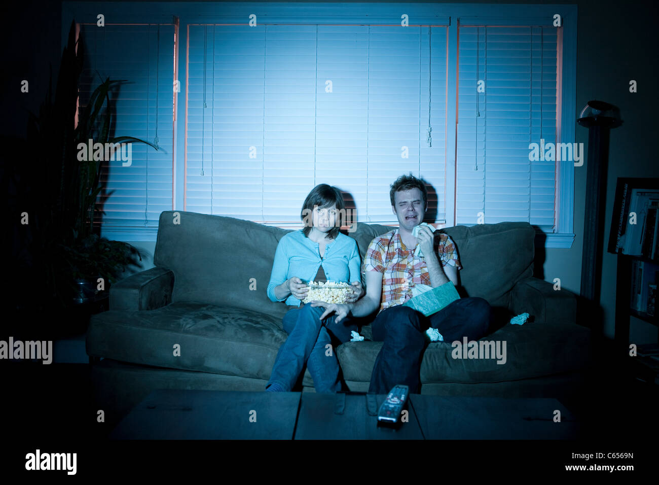 Young couple watching tv, man crying Stock Photo - Alamy