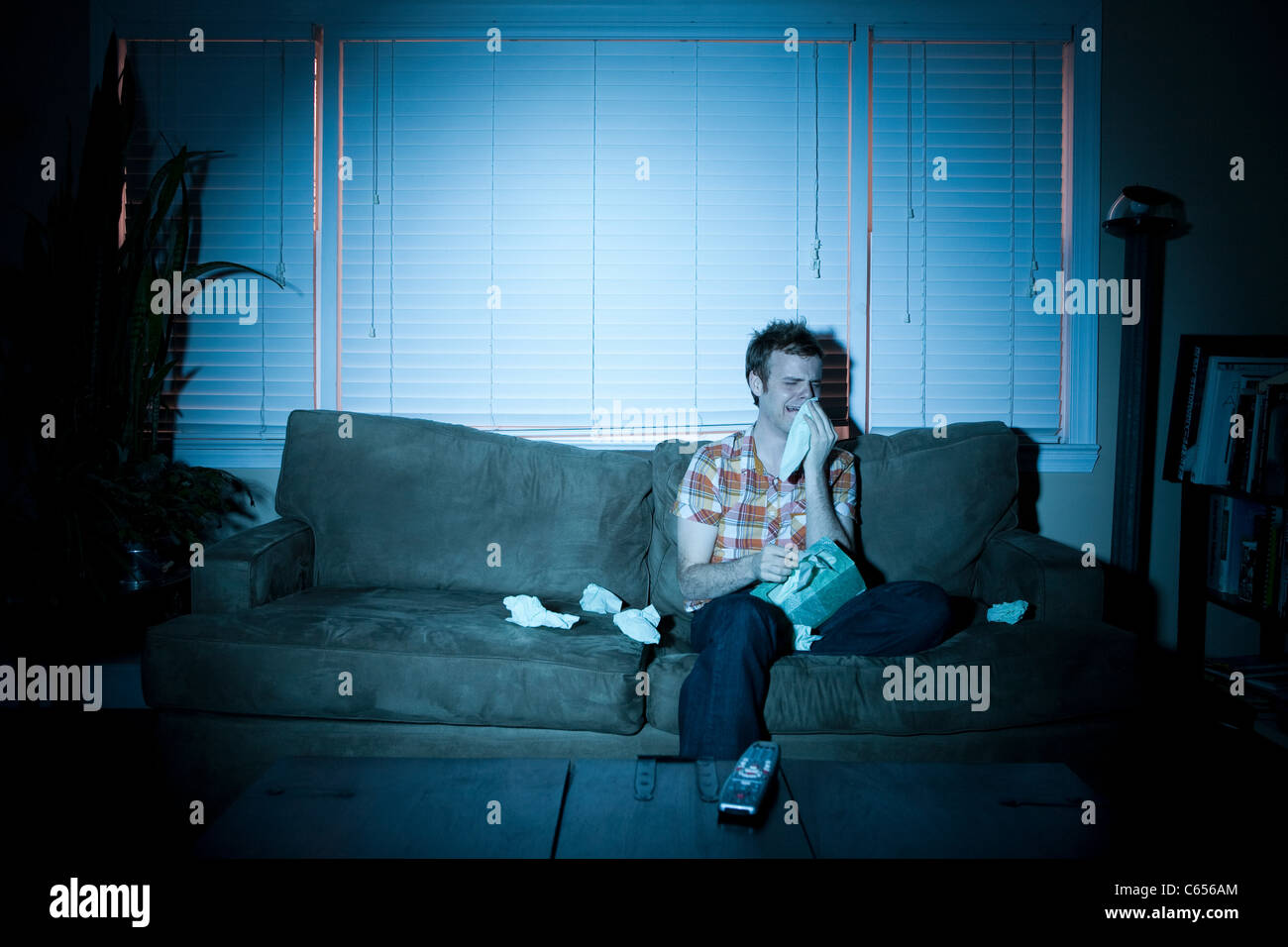 Young man watching tv, crying Stock Photo - Alamy