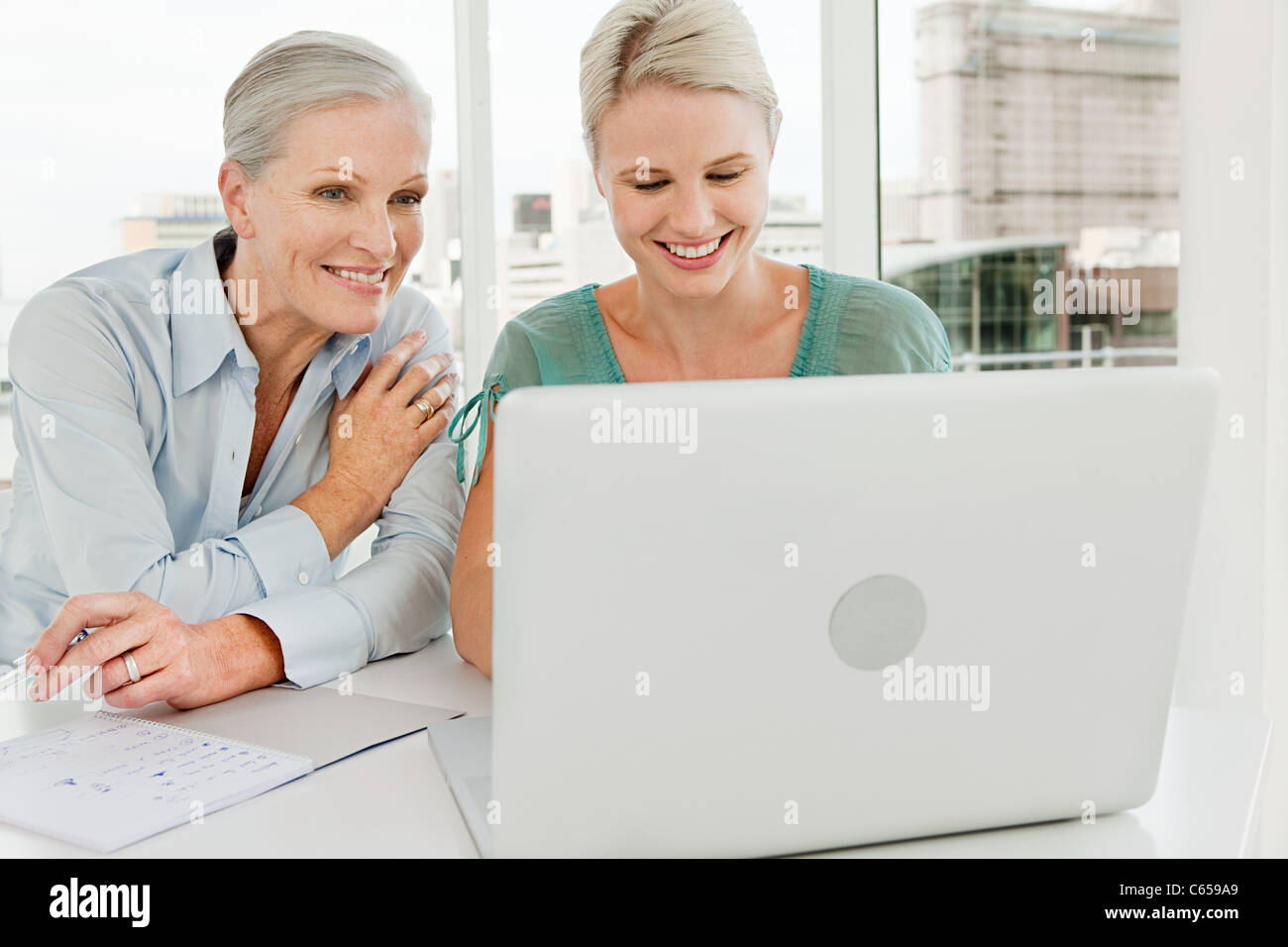 Two businesswomen using laptop in office Stock Photo - Alamy Two businesswomen using laptop in office Stock Photo - Alamy