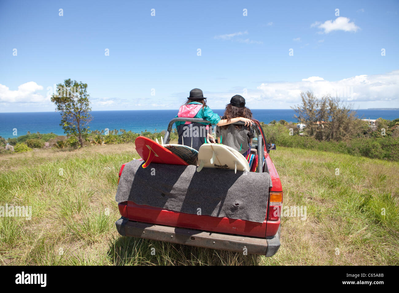 Off road vehicle driving toward beach with two women in back Stock ...