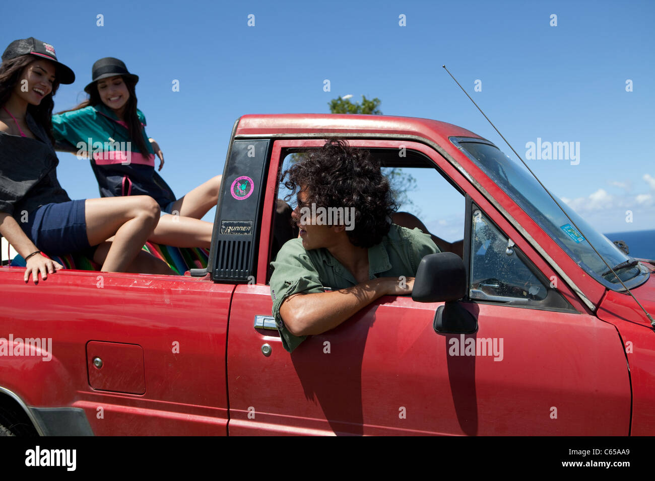 Three young friends driving off road vehicle on vacation Stock Photo ...