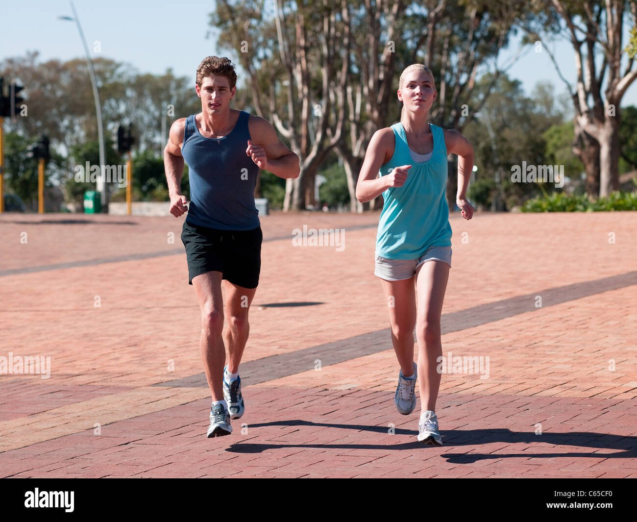 Young couple running Stock Photo - Alamy