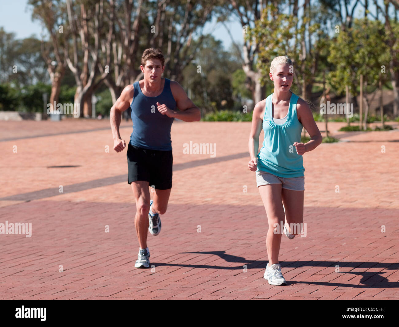 Young couple running Stock Photo - Alamy