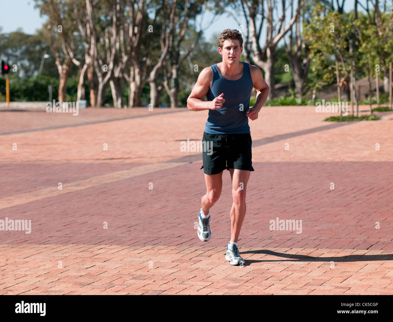 Young man running Stock Photo - Alamy