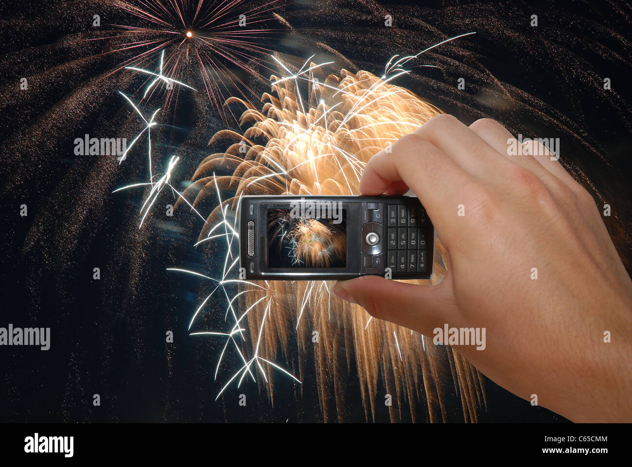 hand holding smartphone capturing fireworks Stock Photo - Alamy
