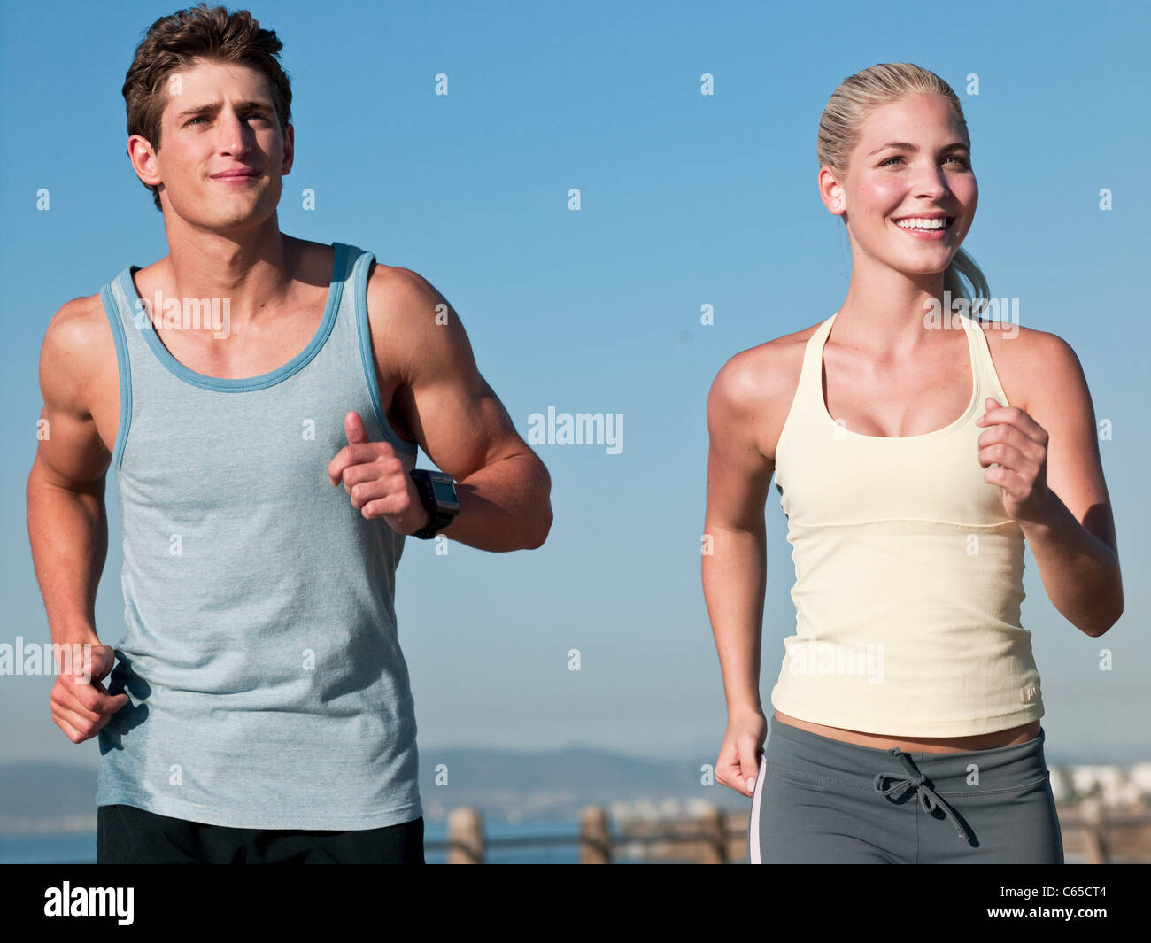 Young couple running Stock Photo - Alamy