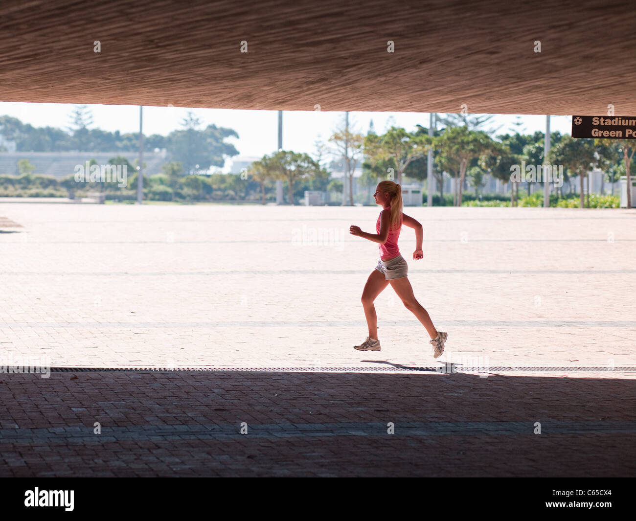 Young woman running Stock Photo - Alamy