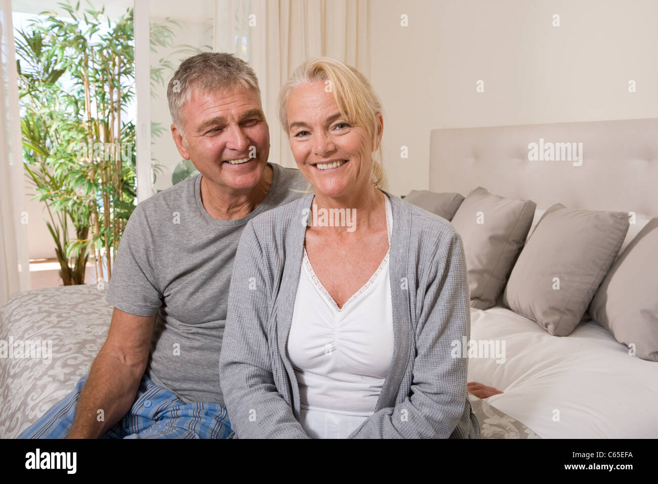Mature couple in bedroom Stock Photo - Alamy