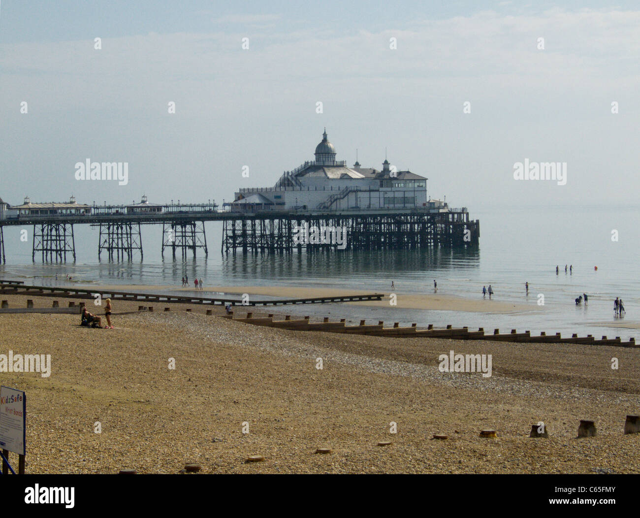 Classic british beach scene pebble beach groynes hazy summer morning hi ...