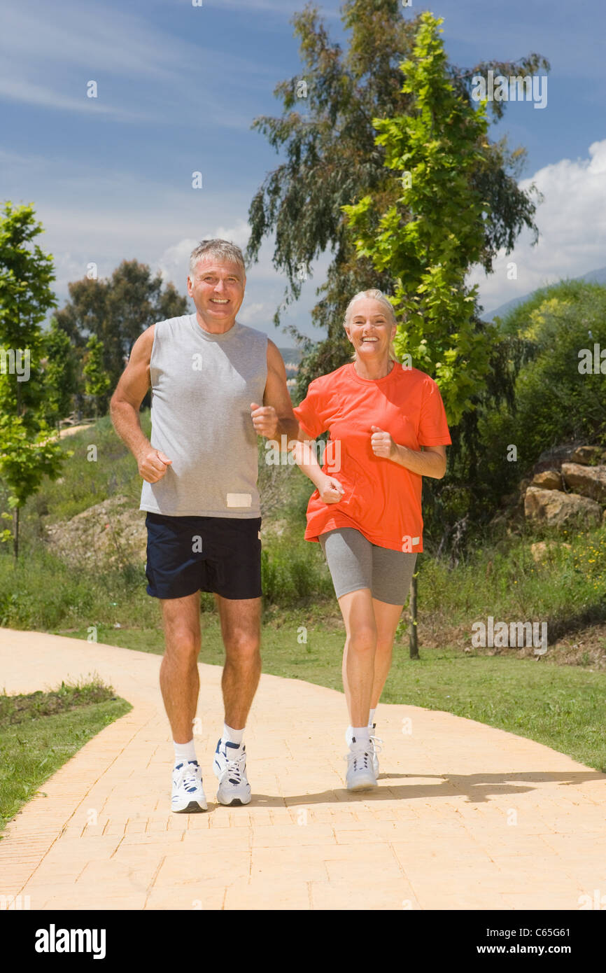 Mature couple jogging together Stock Photo - Alamy