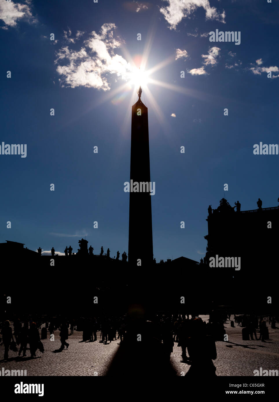 Sun star silhouettes the obelisk in St Peters Square, Vatican City ...