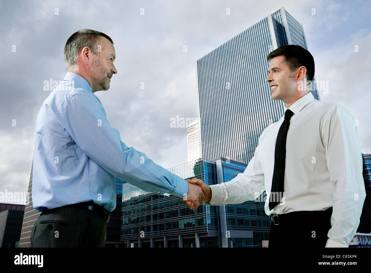 Businessmen shaking hands Stock Photo - Alamy