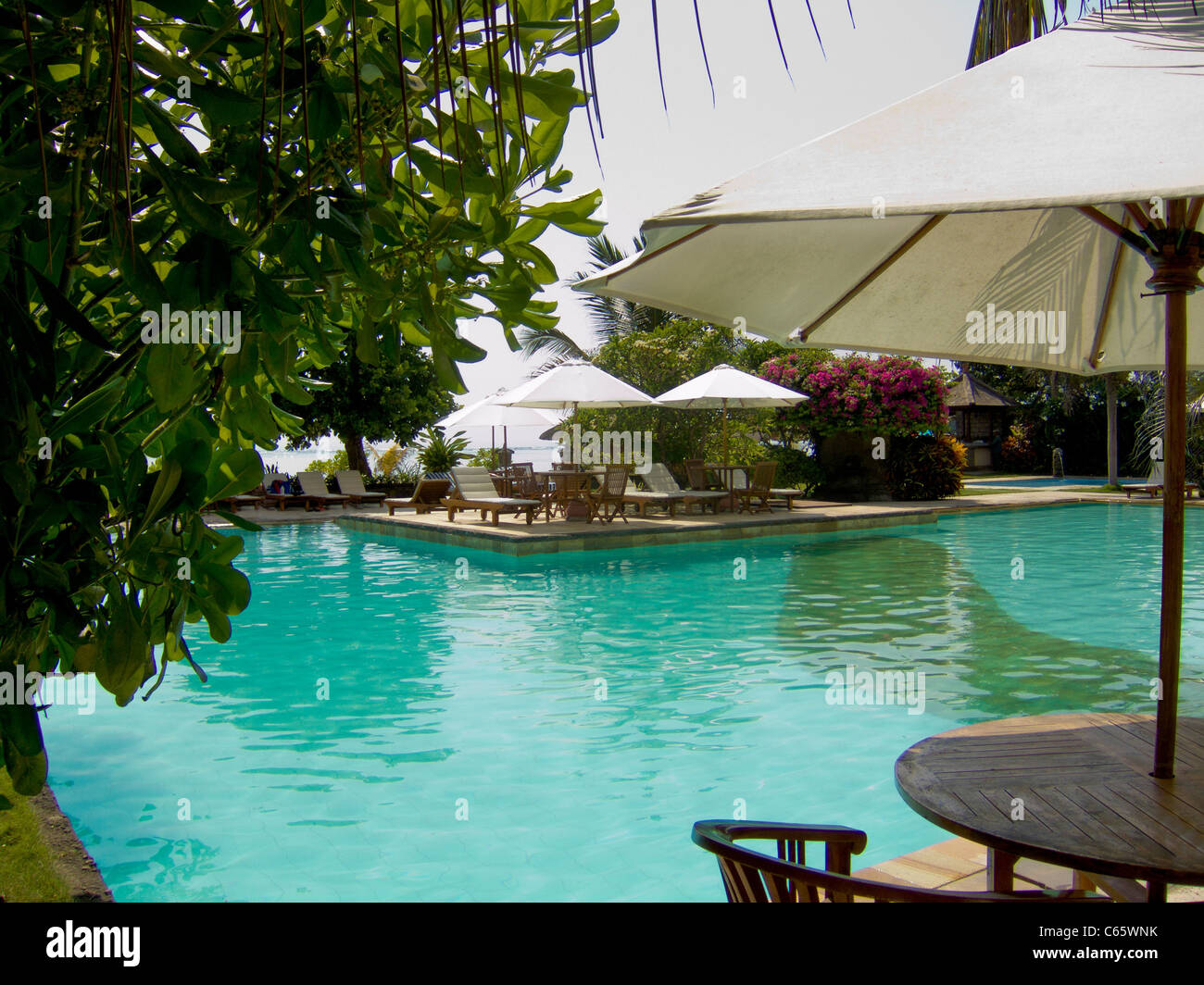 Deserted poolside sun loungers, tables and chairs at Peninsula Beach ...