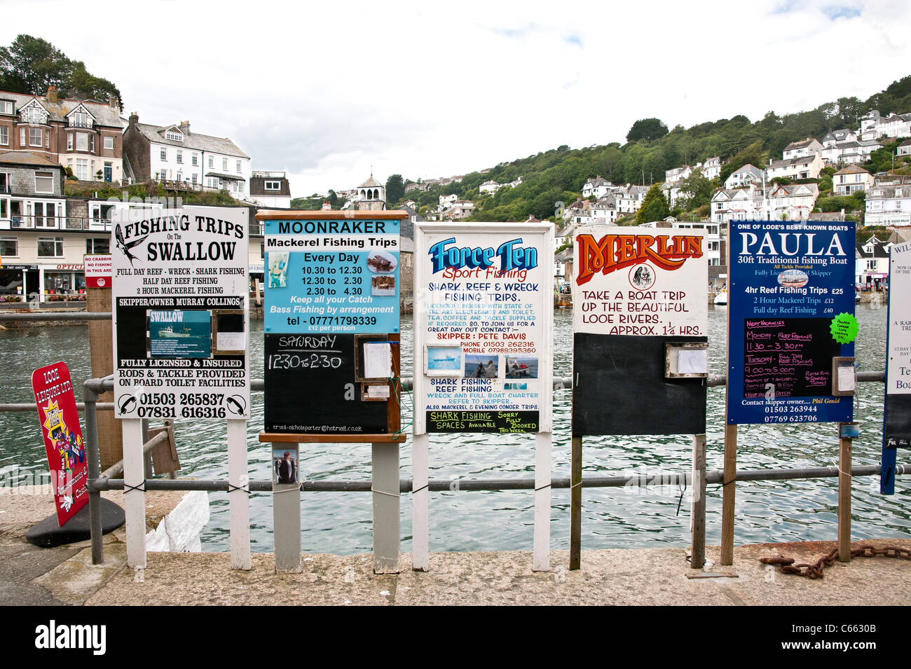 Signs advertising boat trips for pleasure or fishing, from the harbour ...