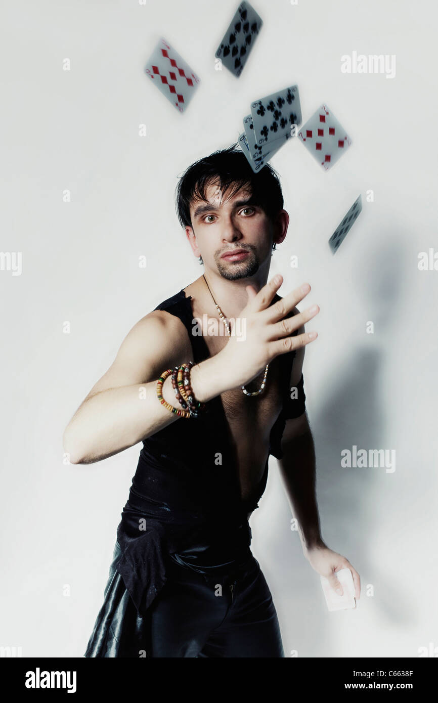 handsome young man throwing playing cards on white background Stock ...