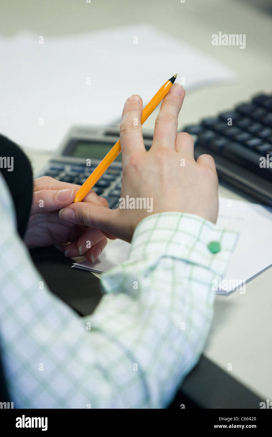 An office worker playing with his pen. London Stock Photo - Alamy