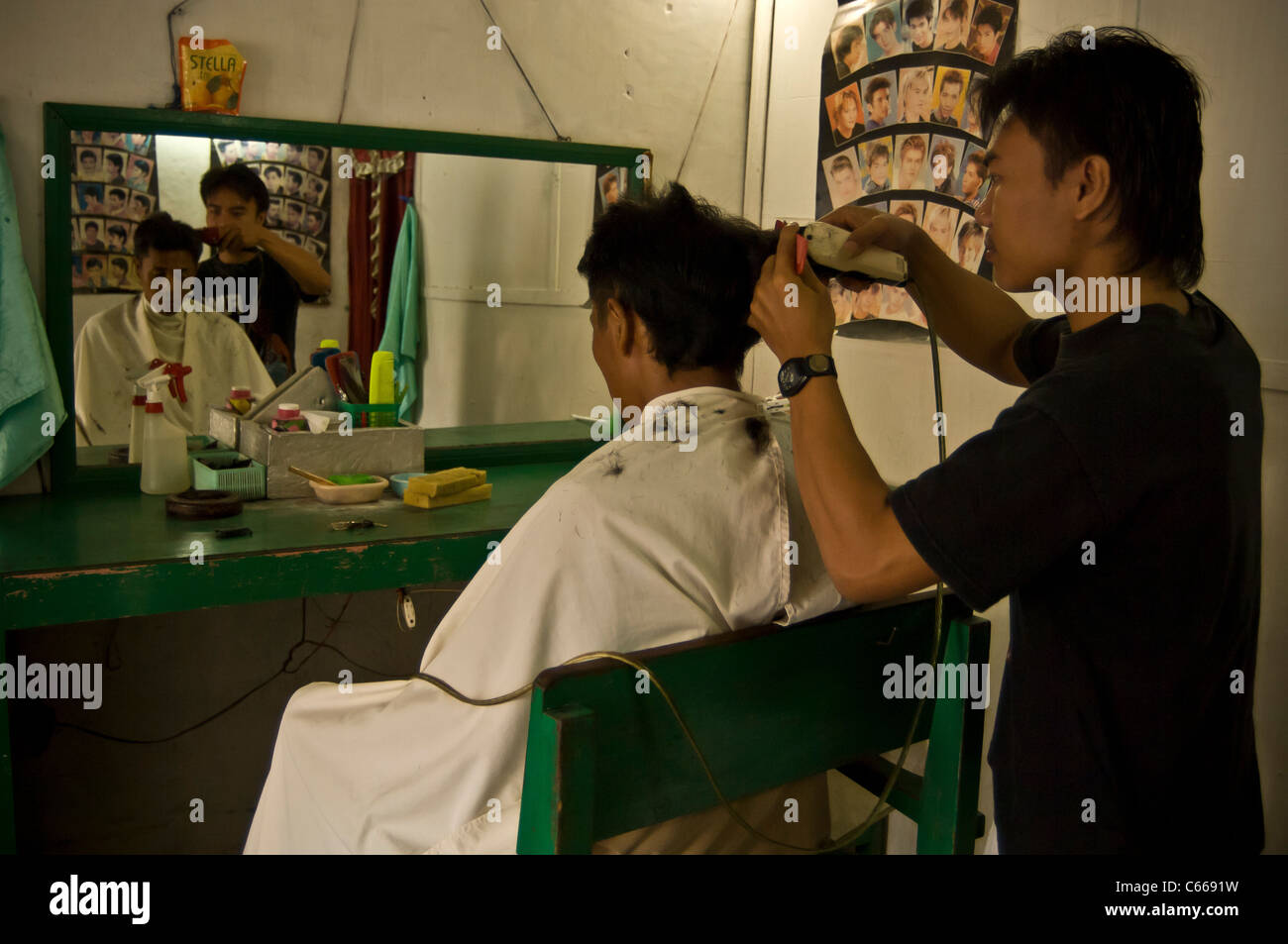 Asian man having haircut at Balinese barber shop Stock Photo - Alamy