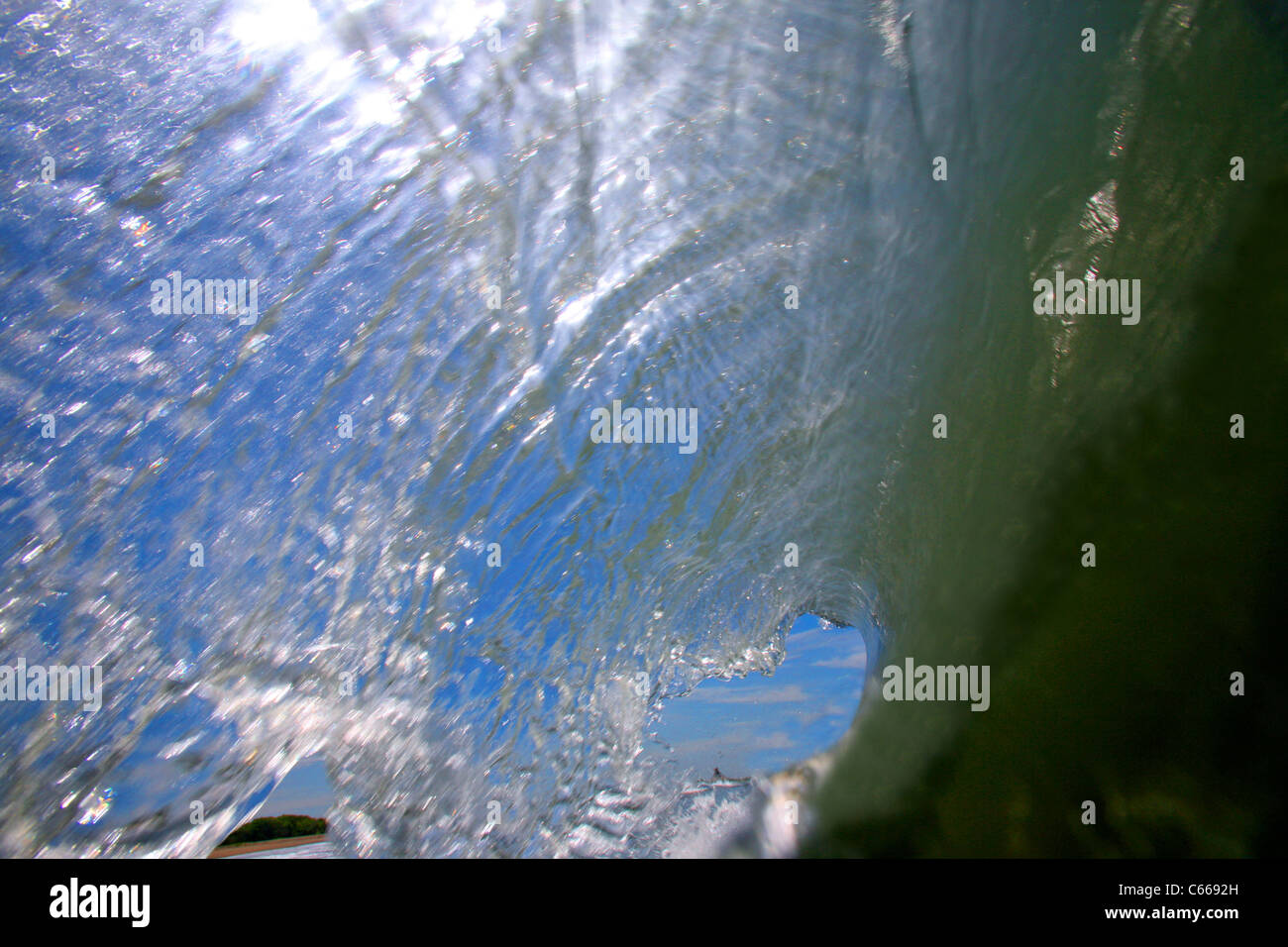A surfer's perspective looking out of the barrel of a hollow wave at ...