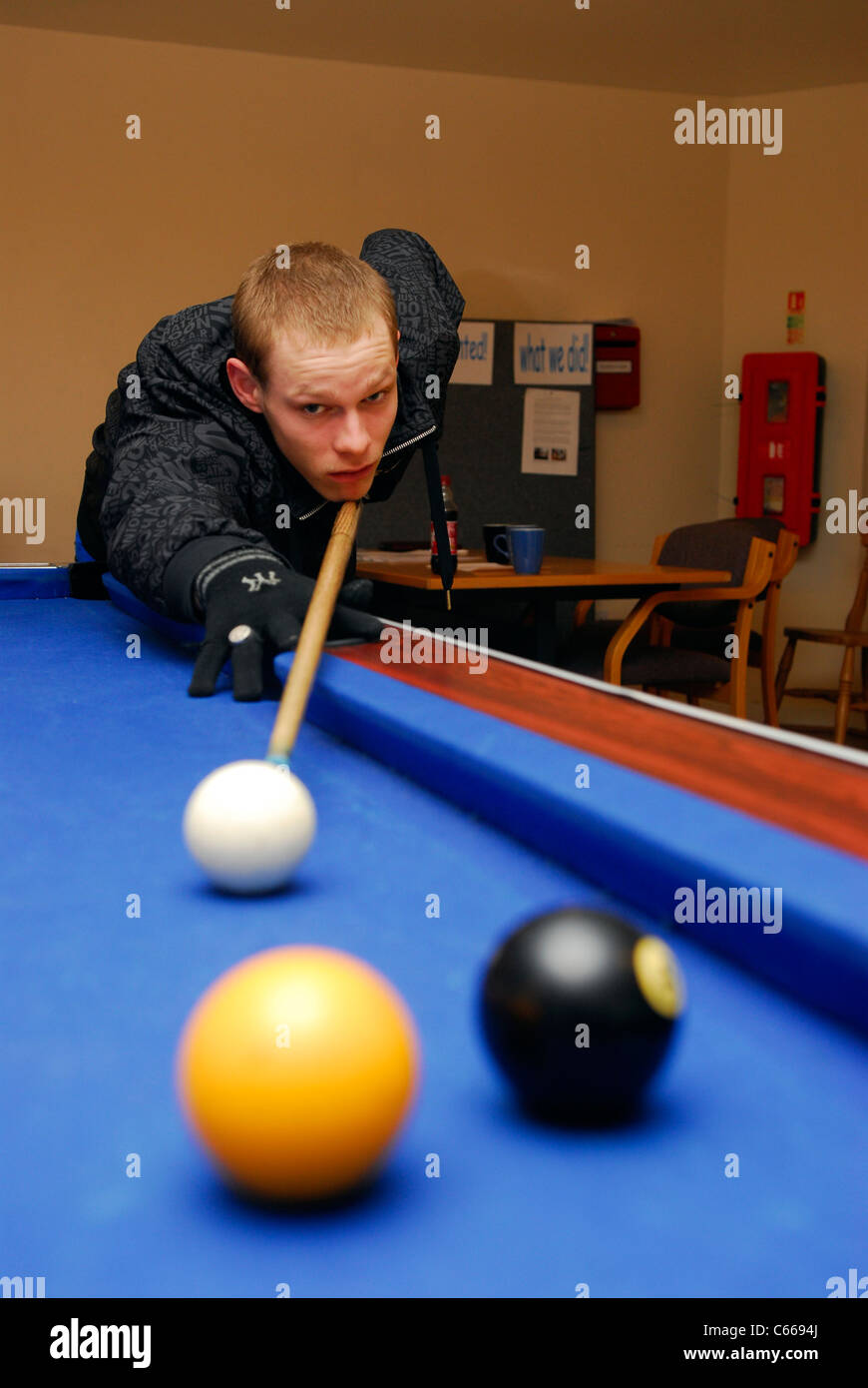 Young man playing pool, Herts, UK Stock Photo - Alamy
