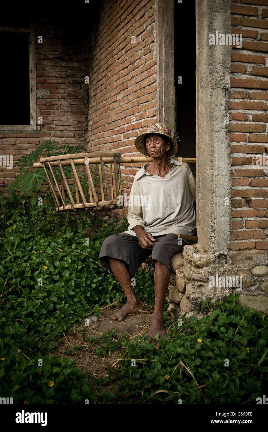 Balinese farmer and weaver in a derelict farm building Stock Photo - Alamy