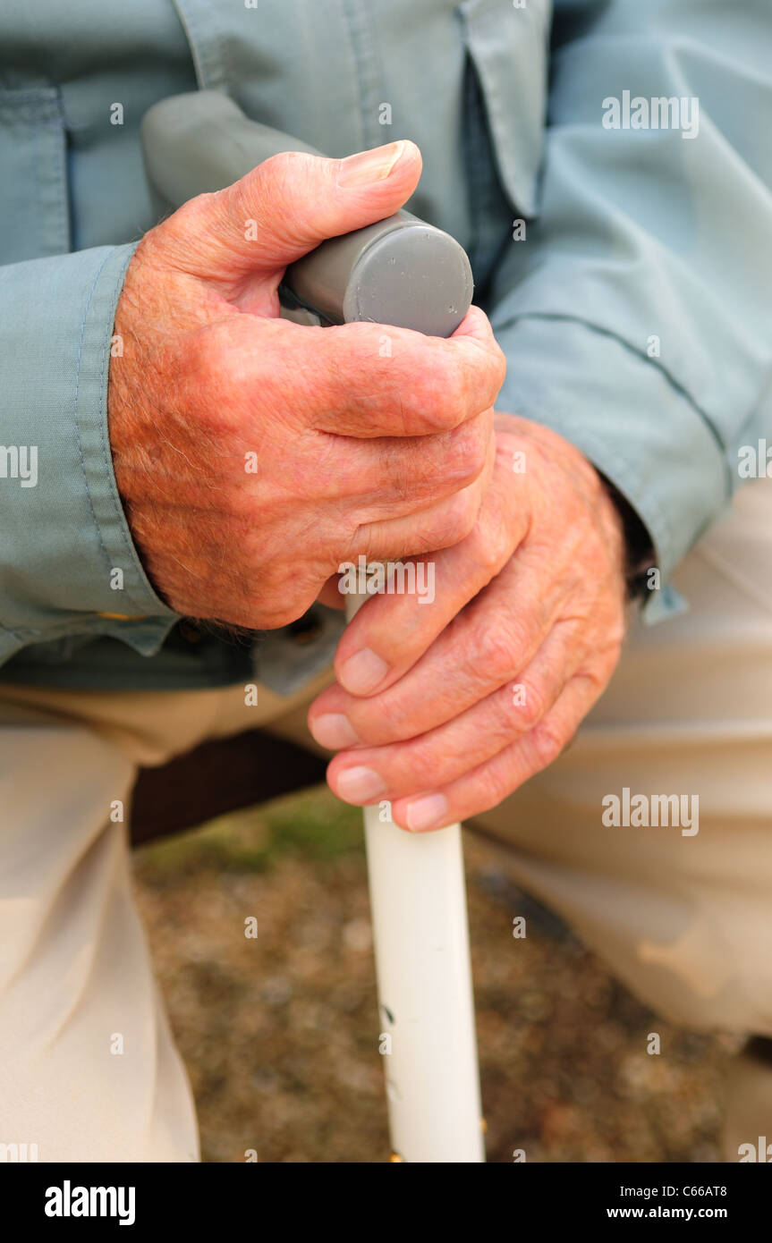 Elderly Man Holding Walking Stick Stock Photo - Alamy