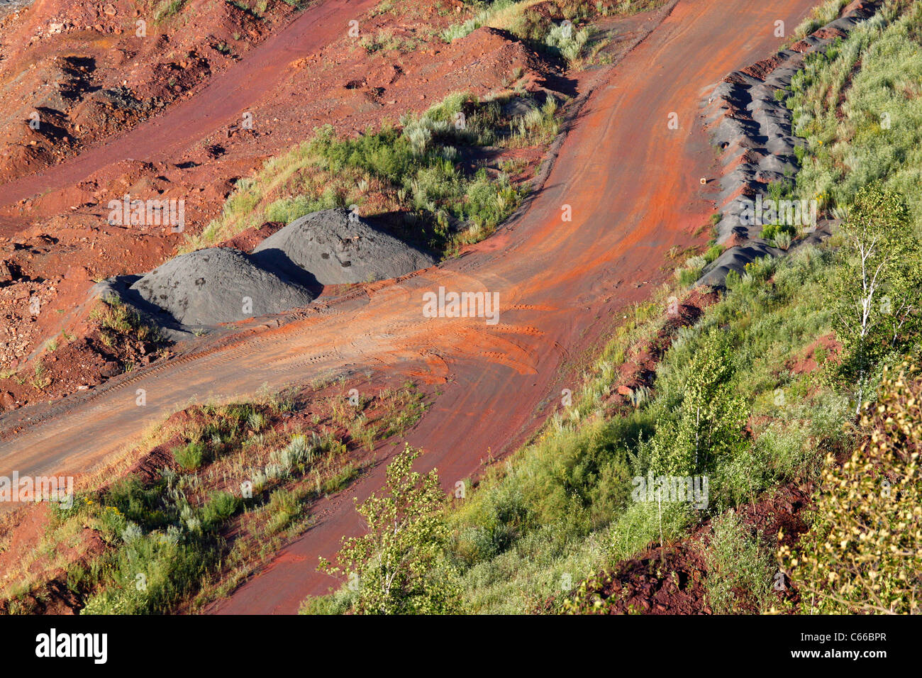 Hull–Rust–Mahoning Open Pit Iron Mine, red rust colored ore on a road ...
