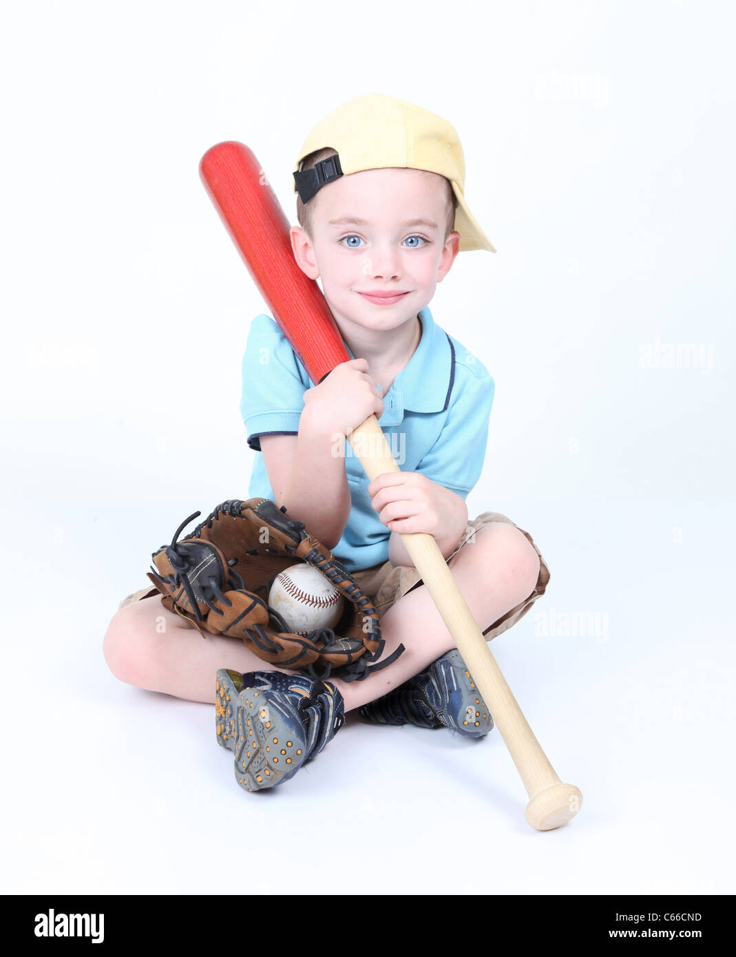 Young boy holding a baseball bat with ball and glove Stock Photo - Alamy