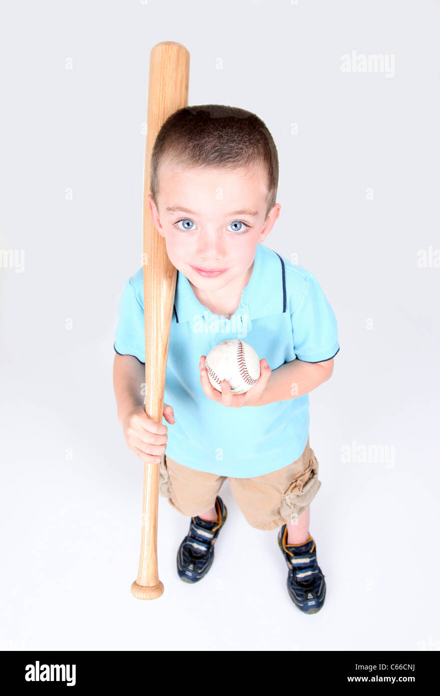 Young boy holding a baseball bat and ball on white background Stock ...