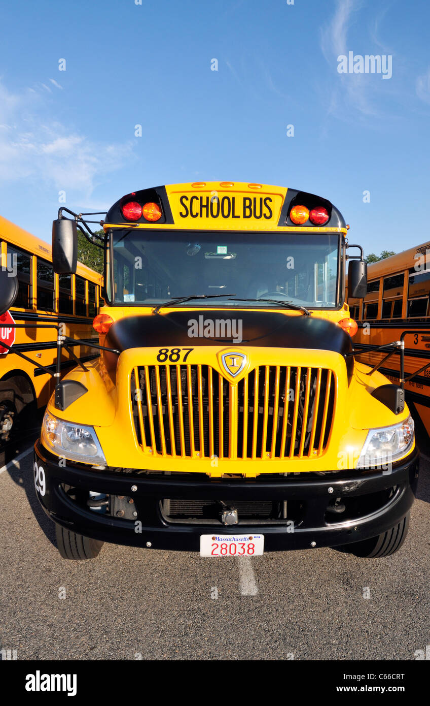 Head-on of a yellow American public school bus surrounded by other ...
