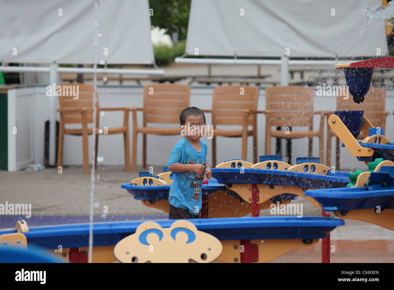 Young boy shivering in cold water while playing at water park Stony ...