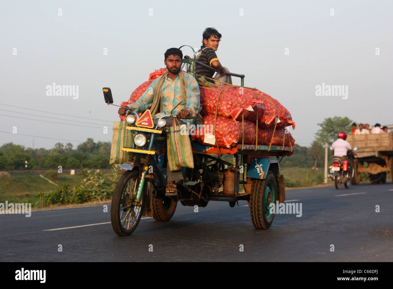 Three wheeler carrier bringing passengers and farm produce to West ...