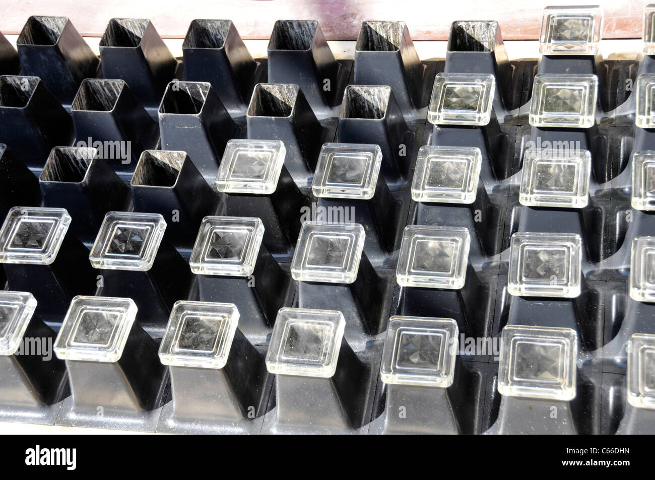 Placing replacement pavement light with square glass lenses on formwork ...