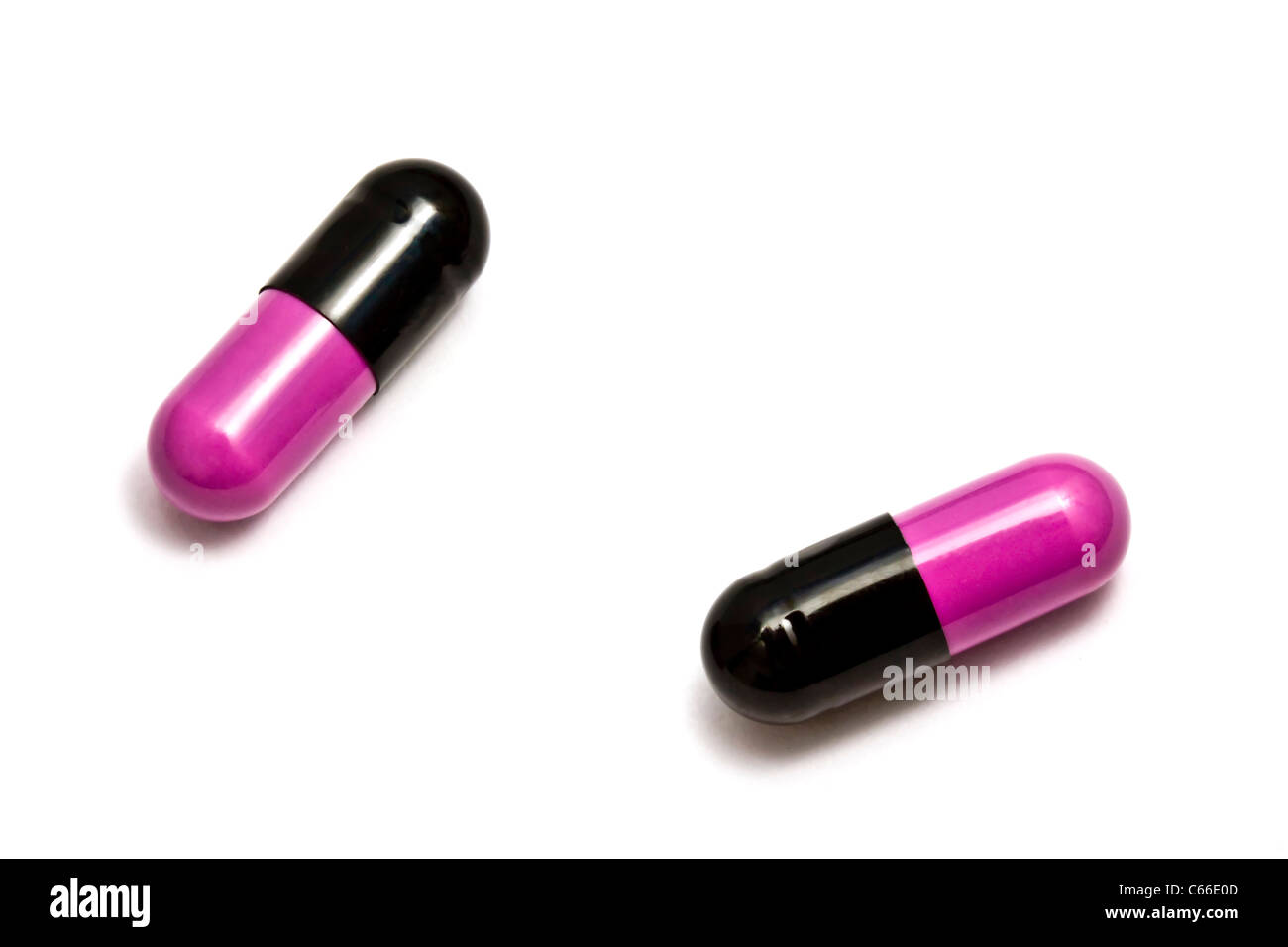 Two capsules isolated on white background Stock Photo - Alamy