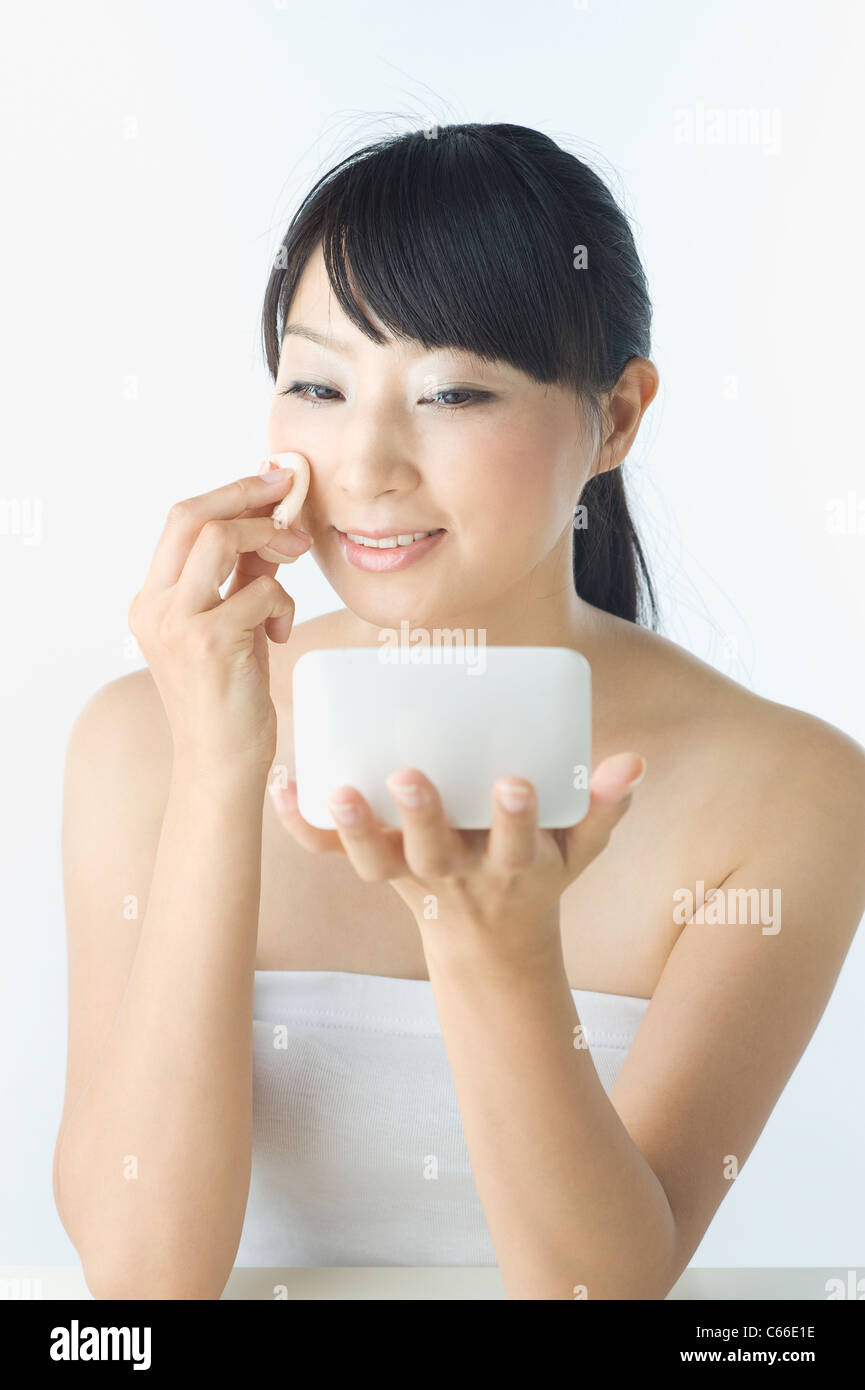 Woman Putting On Foundation High Resolution Stock Photography and ...