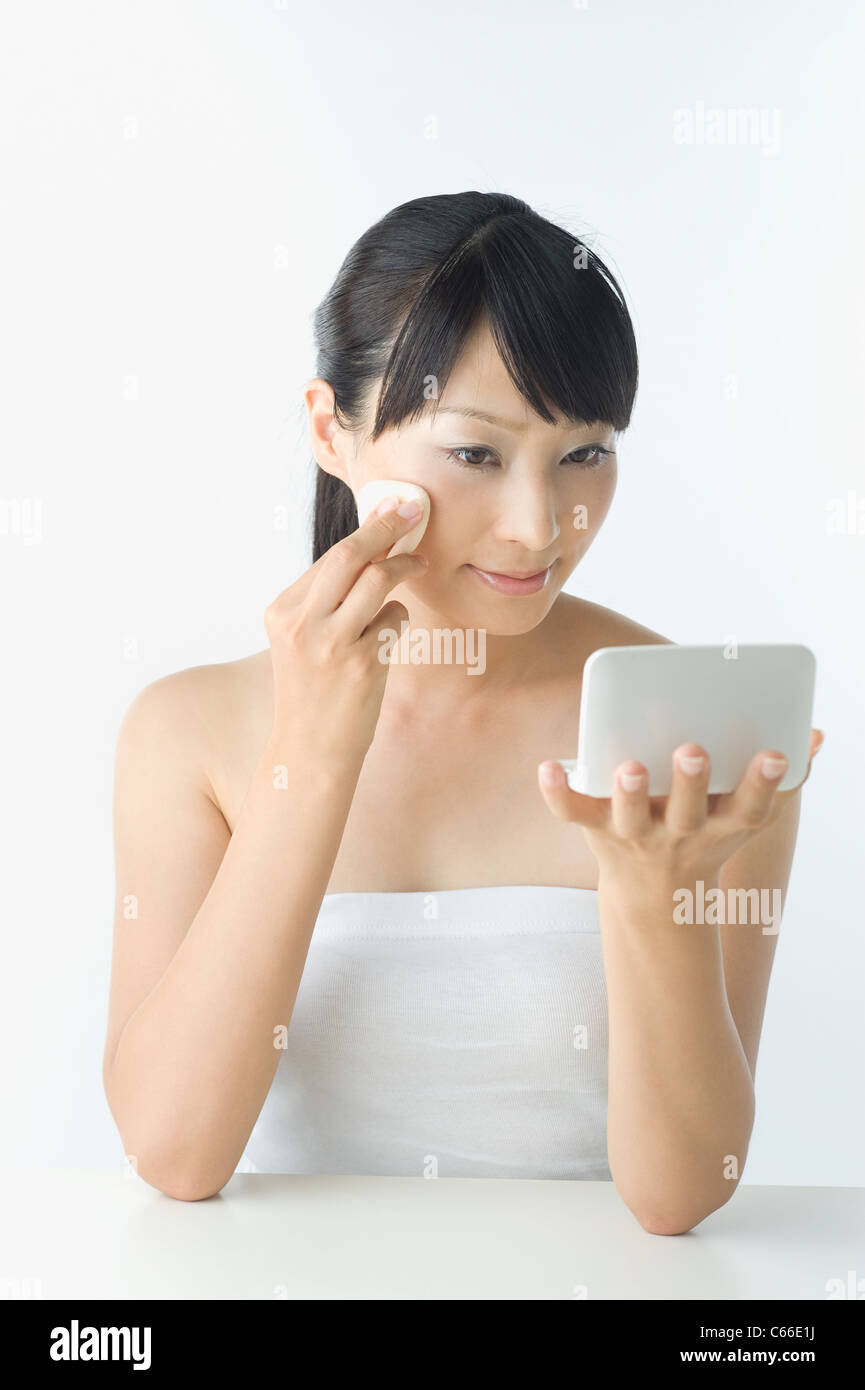 Woman Putting on Foundation Stock Photo - Alamy