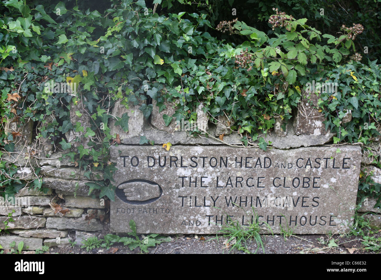 Old stone sign set in dry stone wall. Swanage Durlson Country Park ...