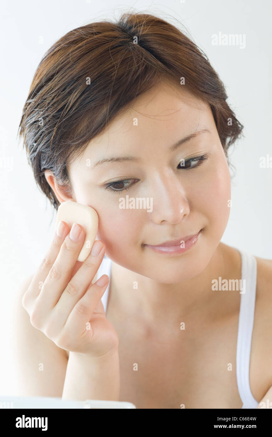 Woman Putting On Foundation High Resolution Stock Photography and ...