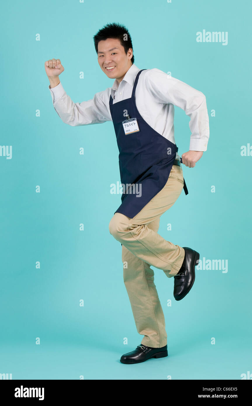 Clerk with Apron Making a Pose Stock Photo - Alamy