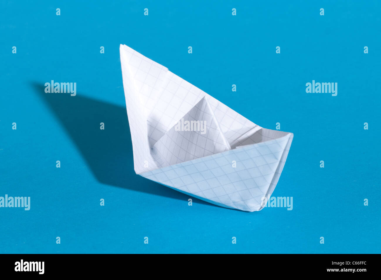 Paper ship, photo on the blue background Stock Photo - Alamy