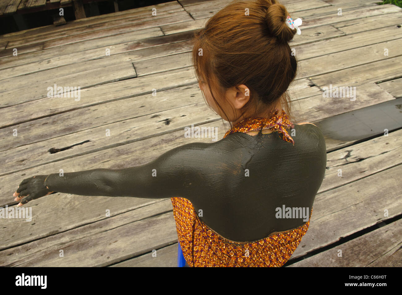 Thai woman enjoying a therapeutic mud treatment at the Phu Klon Mud Spa ...