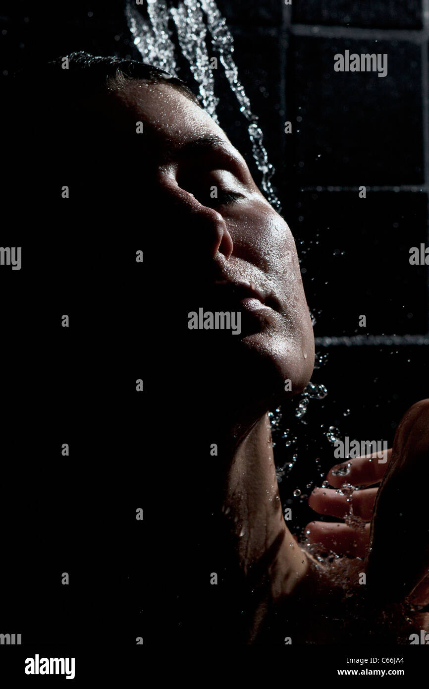 Portrait of a woman taking a shower Stock Photo - Alamy