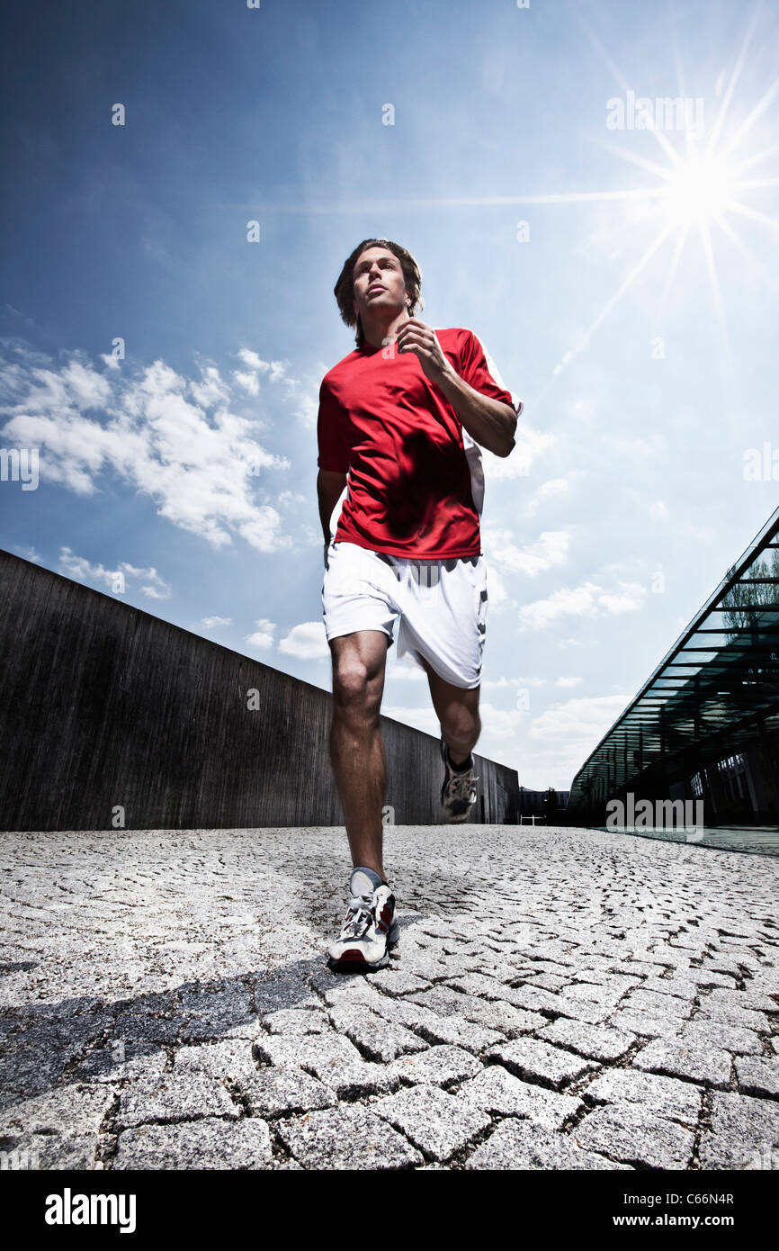 Man running on city street Stock Photo - Alamy