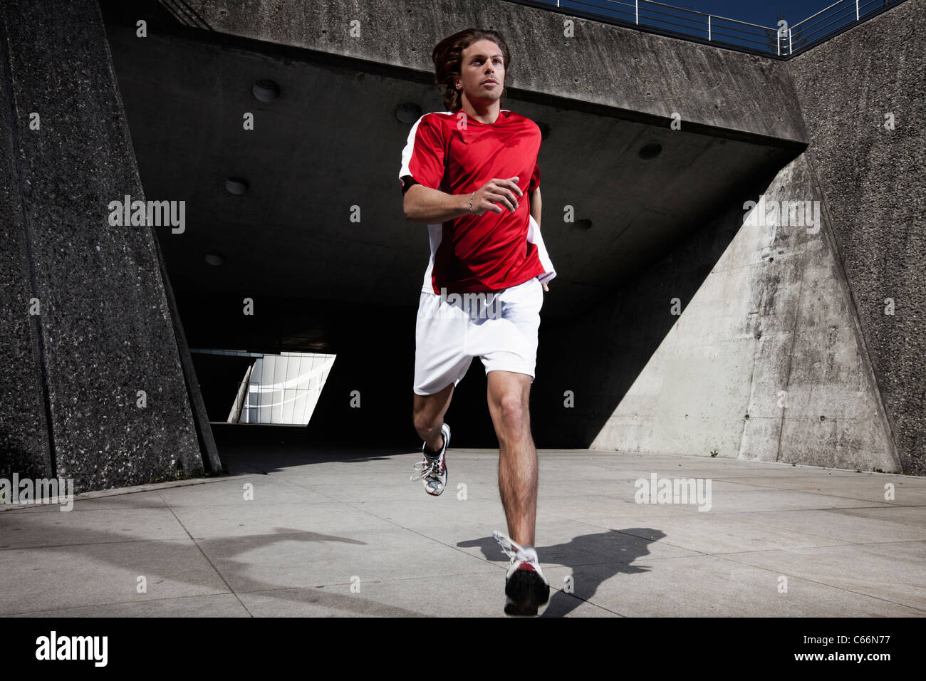 Man running on city street Stock Photo - Alamy