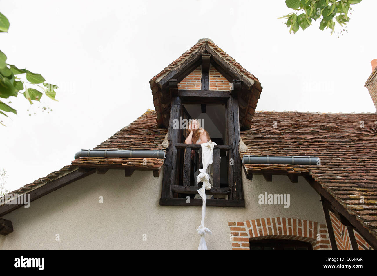 Woman with sheet tossed out her window Stock Photo - Alamy
