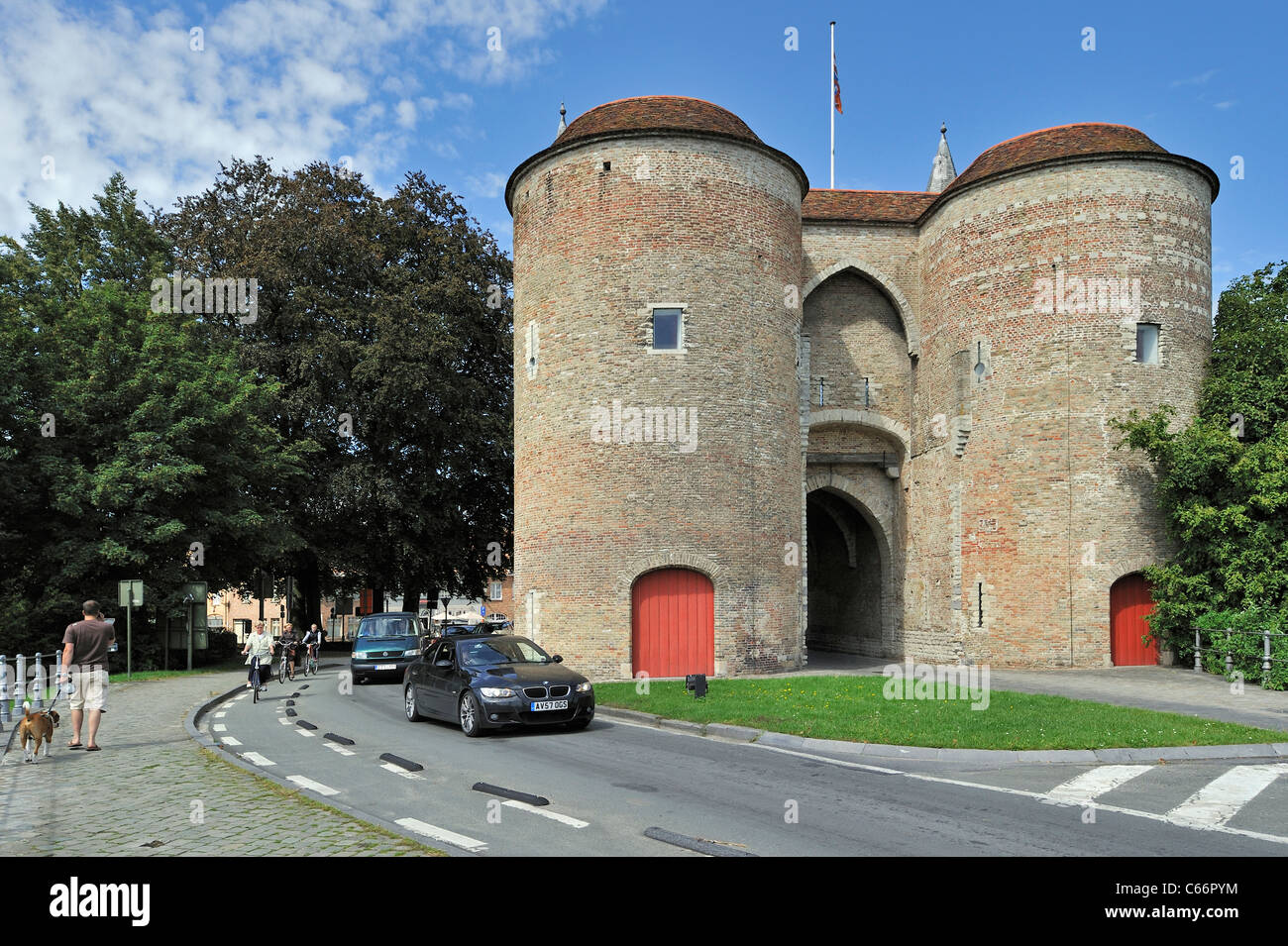 Traffic leaving town and the city gate Gentpoort / Ghent Gate in Bruges ...