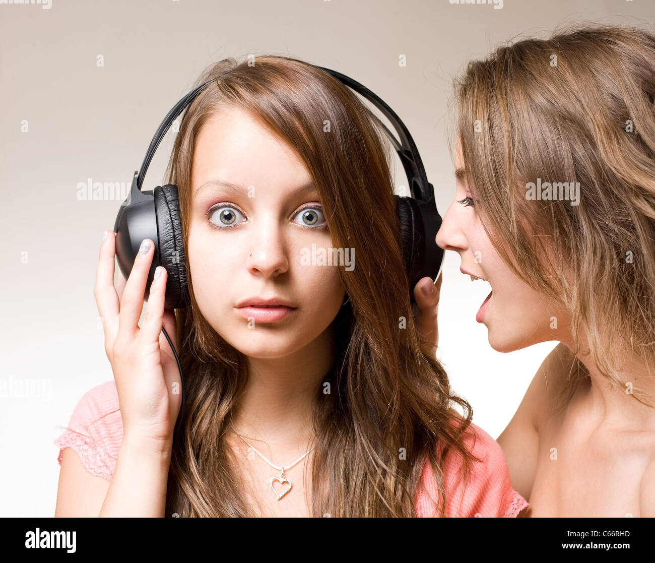 Share the music, two gorgeous brunette girls one shouting into other's ...