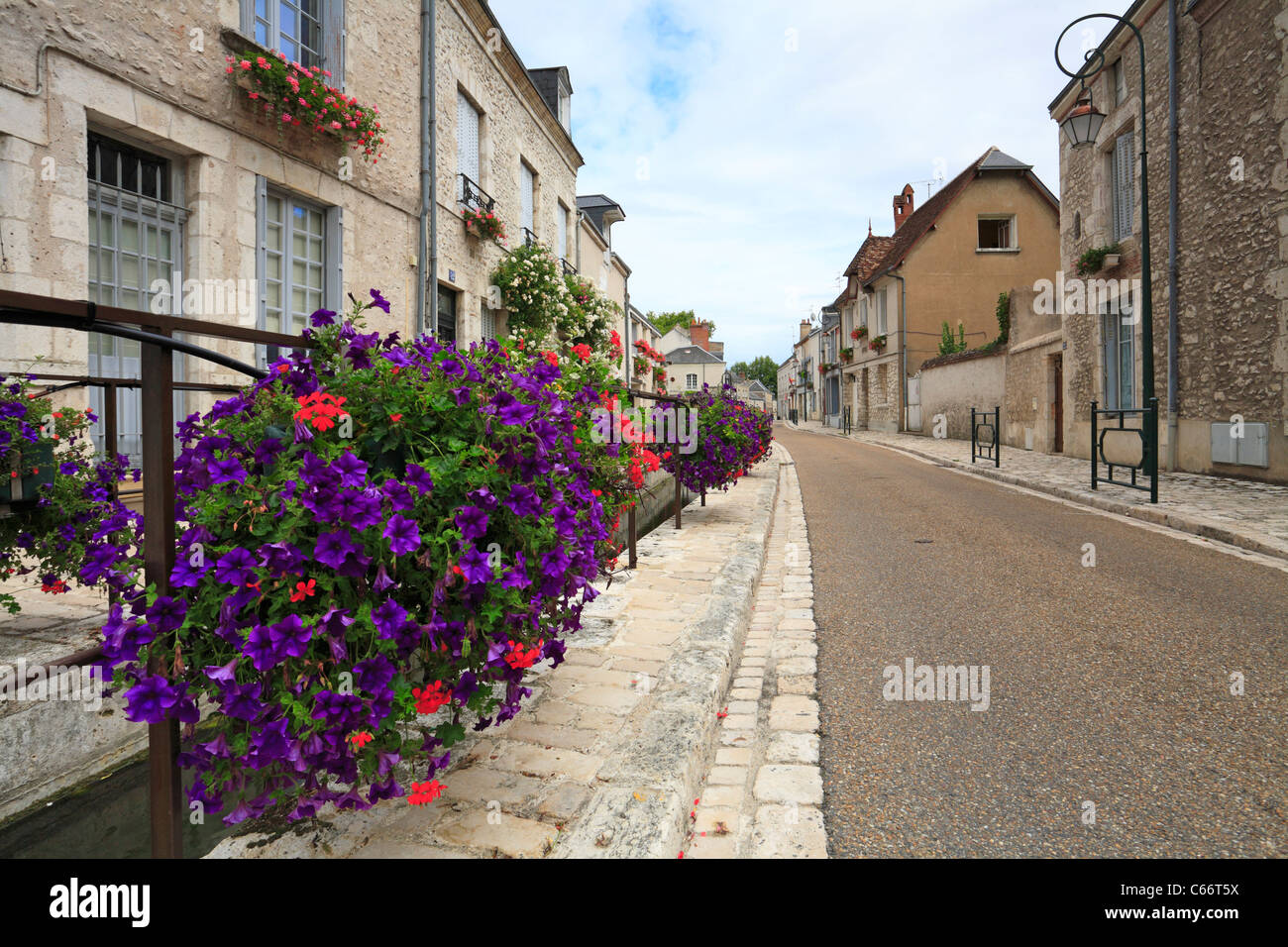 Flower lined Rue du Pont in the medieval town of Beaugency in the Loire ...