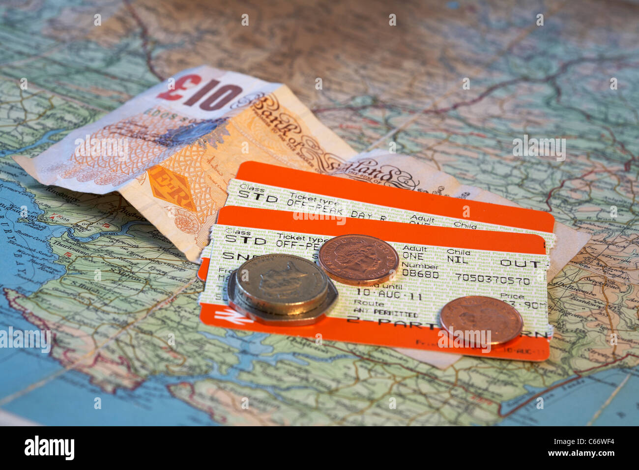 Rail Tickets and cash laying on map Stock Photo - Alamy