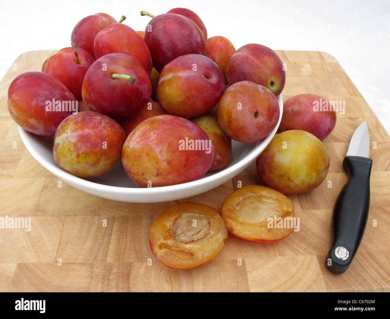 Victoria Plums in a White Bowl Stock Photo - Alamy